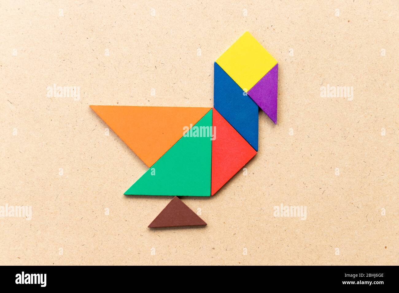 Color tangram puzzle in duck, swan or goose shape on wood background ...
