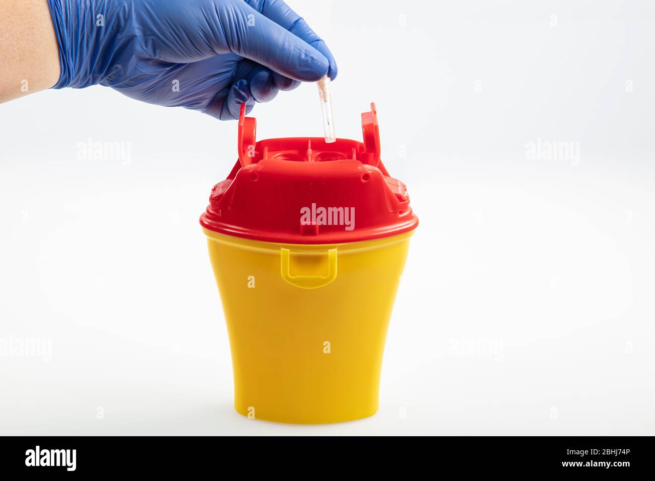 Health worker throws sharp waste into the medical waste bin. Medical ...