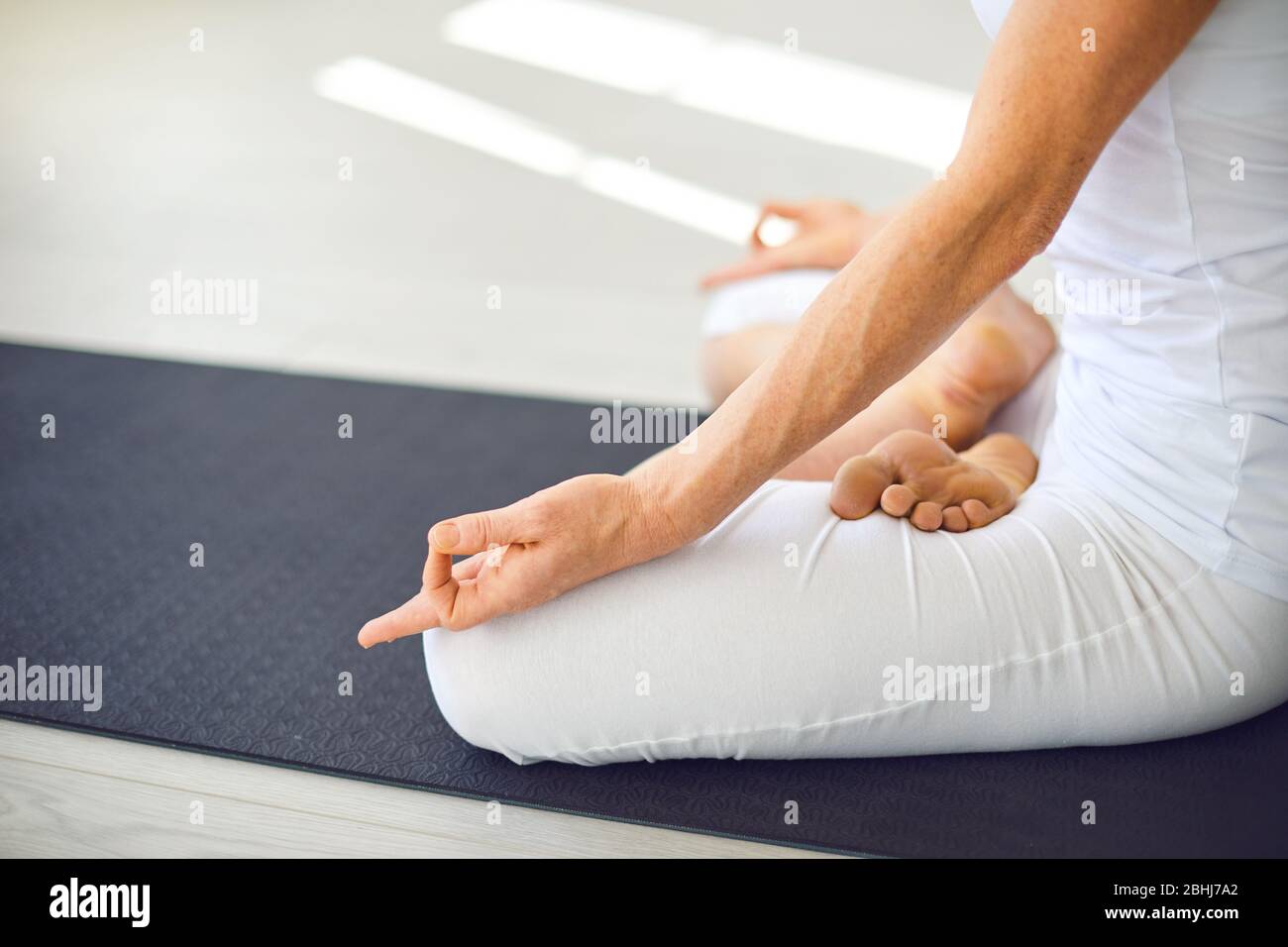 Close up of yoga woman hand sitting relaxation in lotus field on floor ...