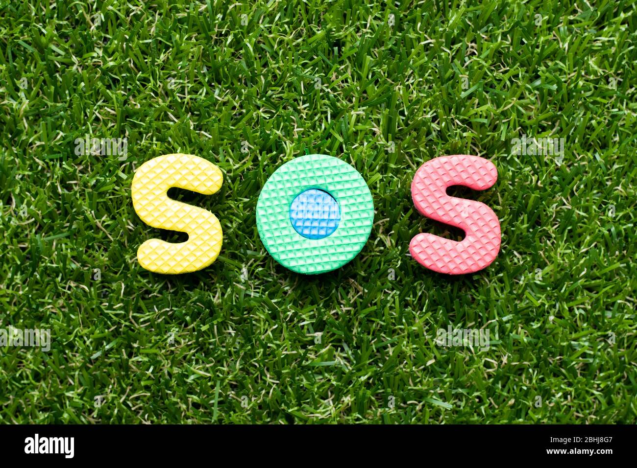 Toy foam letter in word SOS (abbreviation of save our soul/ship or ...