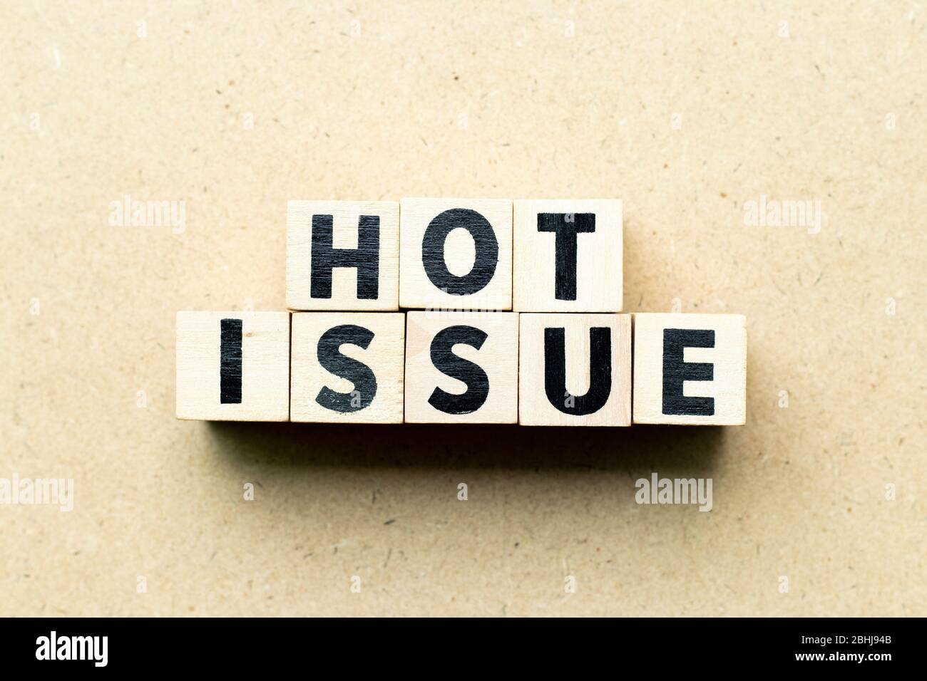 Letter block in word hot issue on wood background Stock Photo - Alamy