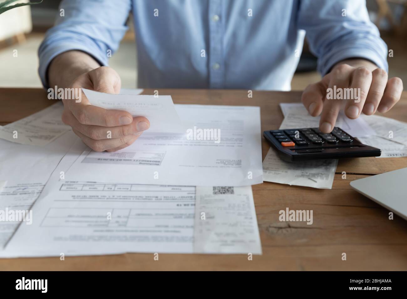 Close up man checking bills, holding receipt, using calculator Stock ...