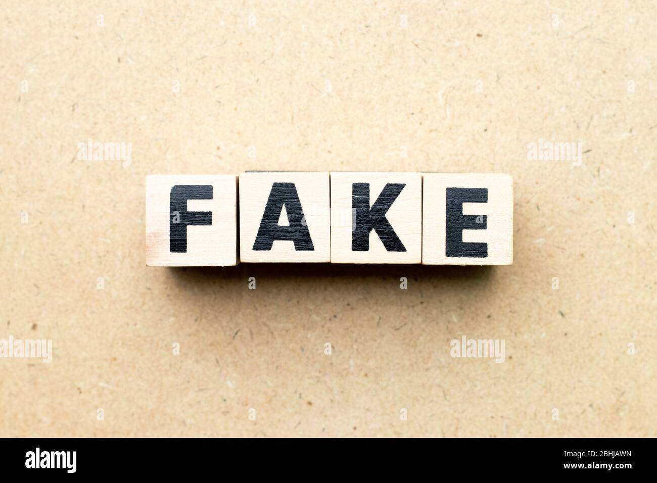 Letter block in word fake on wood background Stock Photo - Alamy