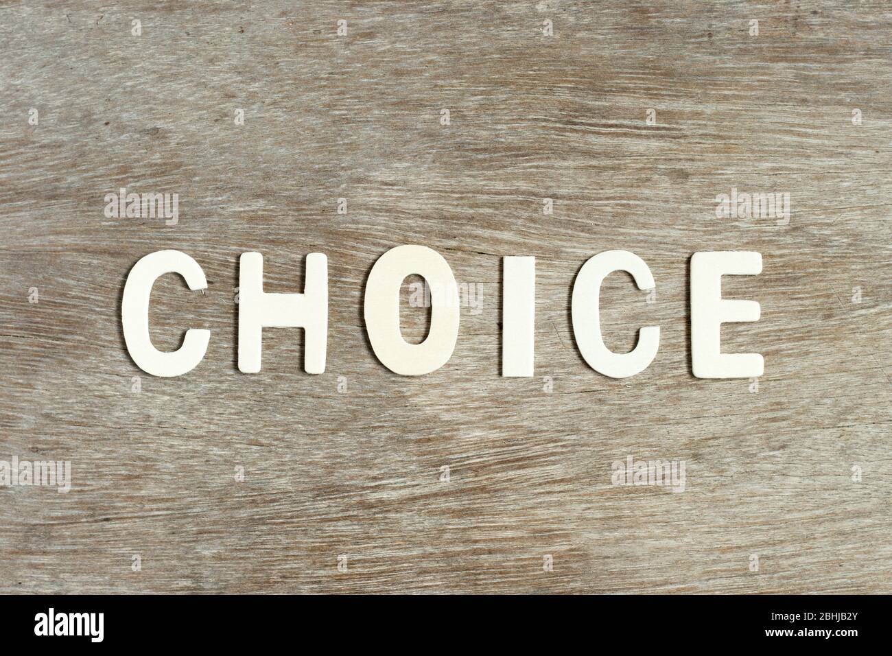 Alphabet letter in word choice on wood background Stock Photo - Alamy