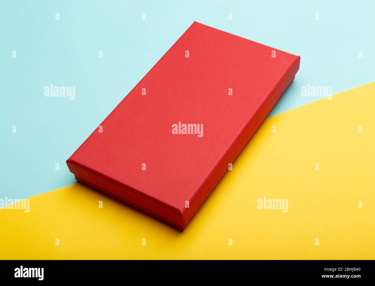 Red box product packaging isolated on yellow half blue background Stock ...