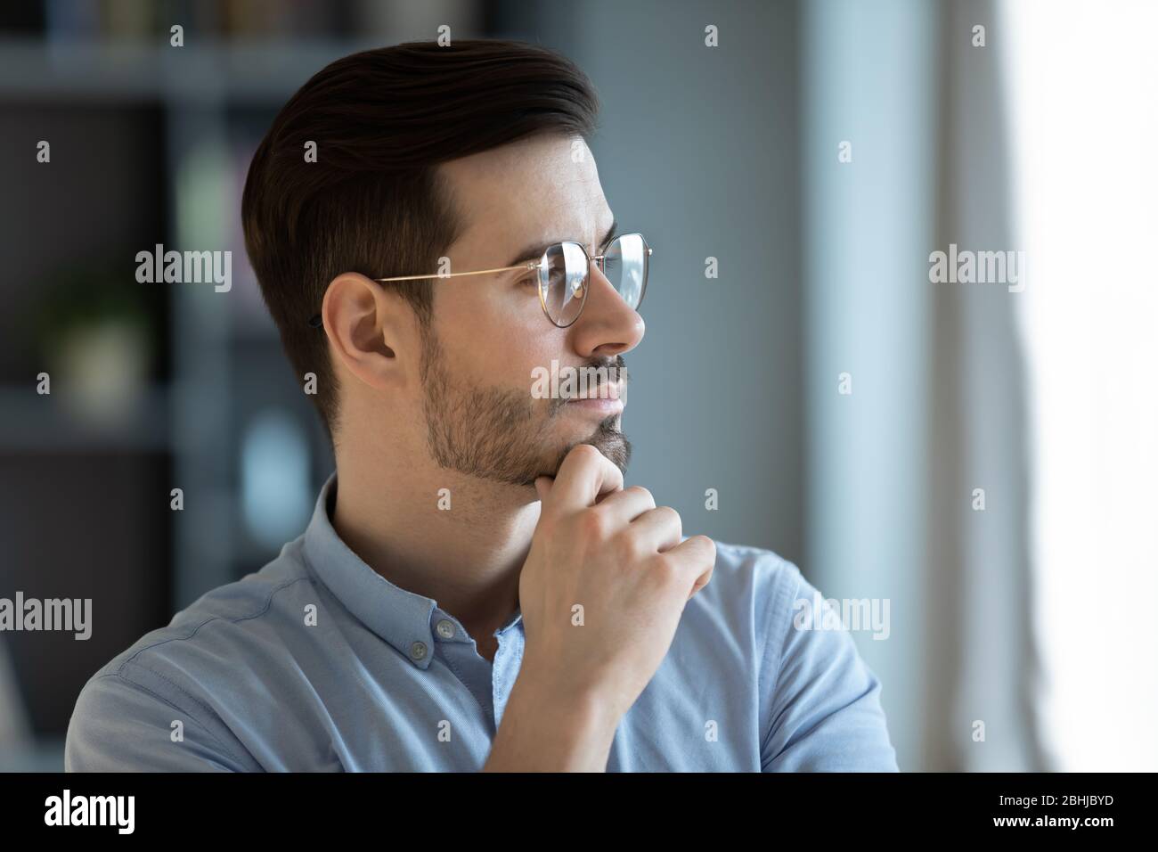 Serious employee looking aside hi-res stock photography and images - Alamy