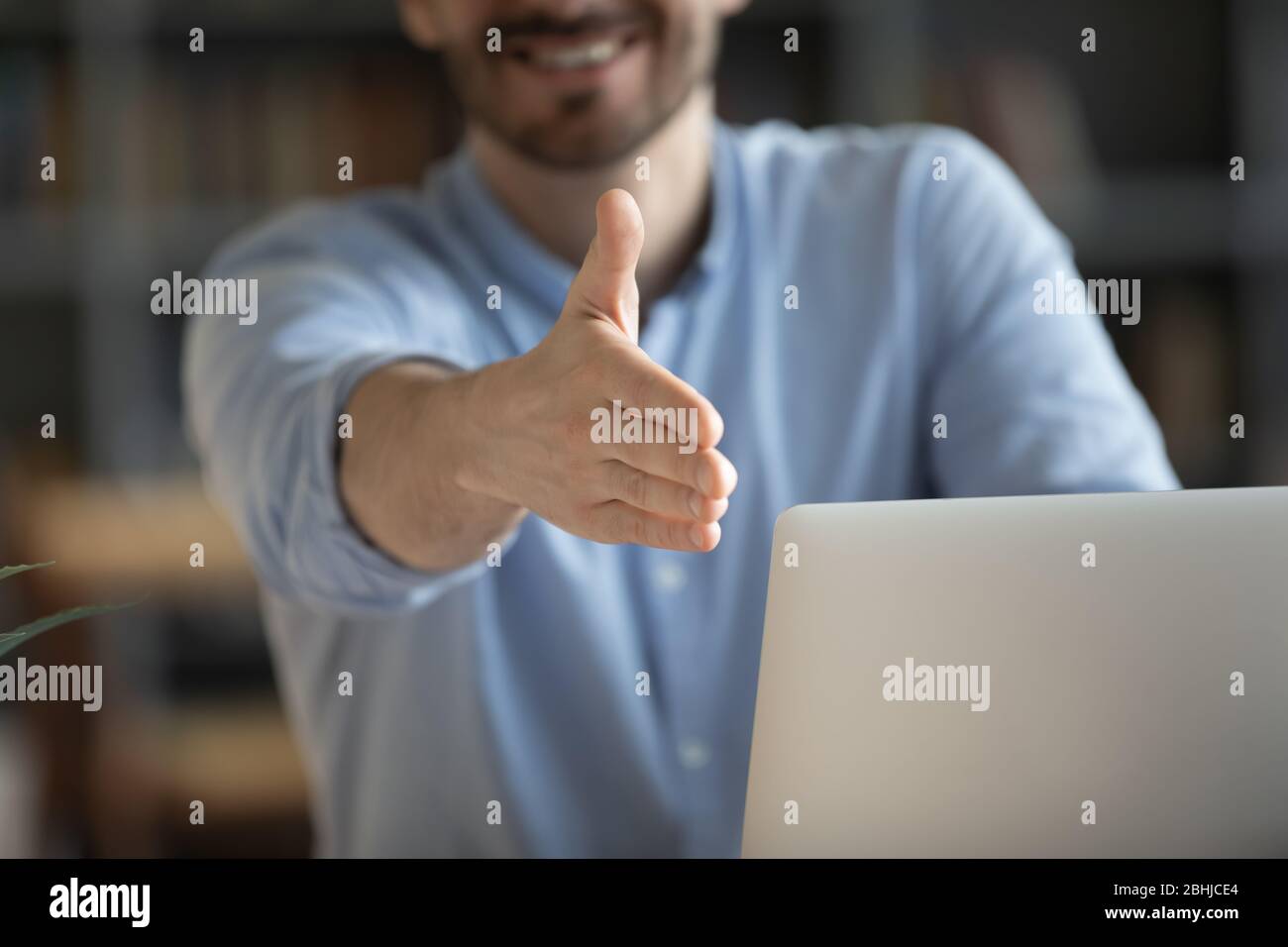 Close up smiling friendly businessman extending hand for handshake ...