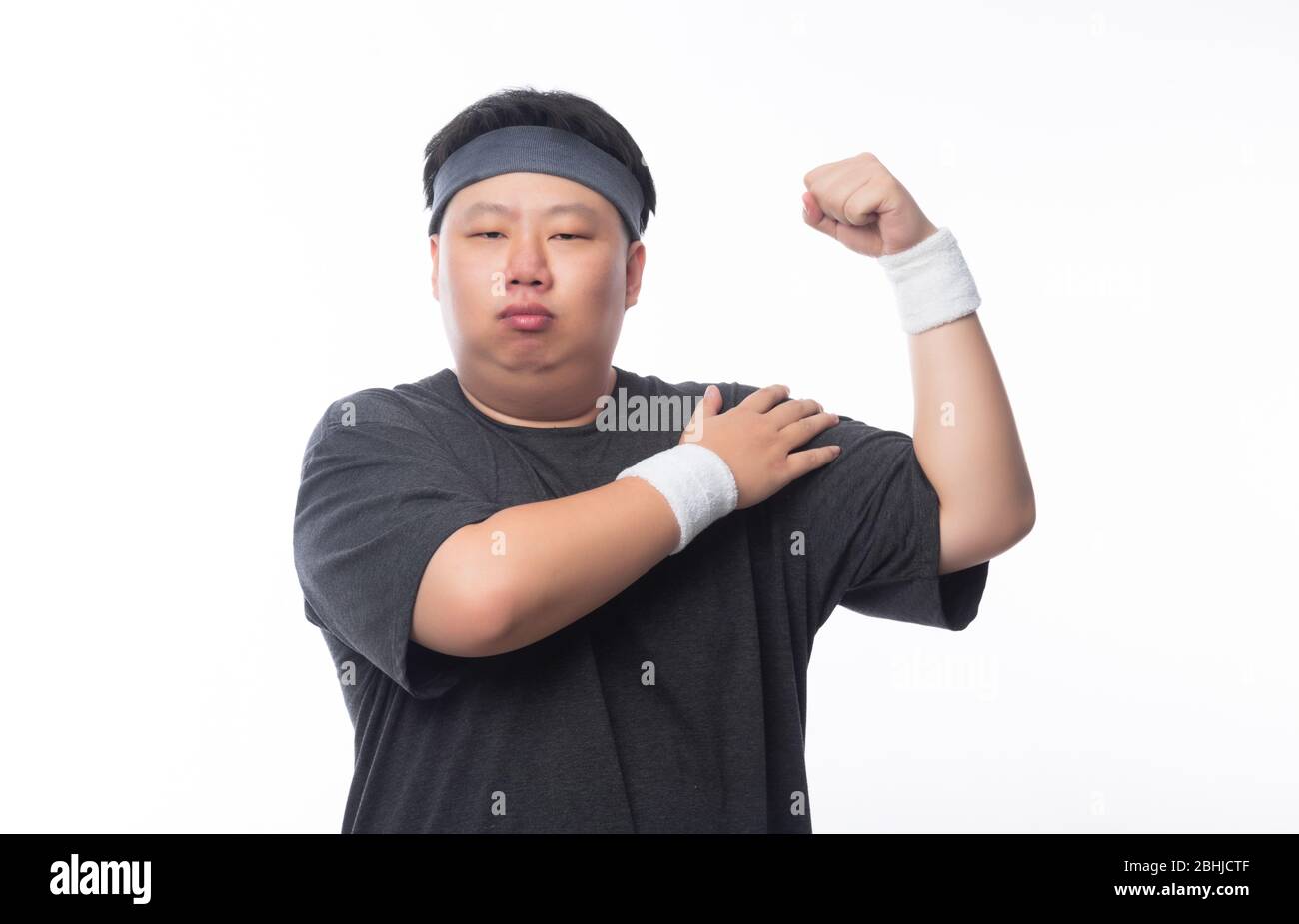 Asian funny fat man in sport outfits showing strenght and looking to ...
