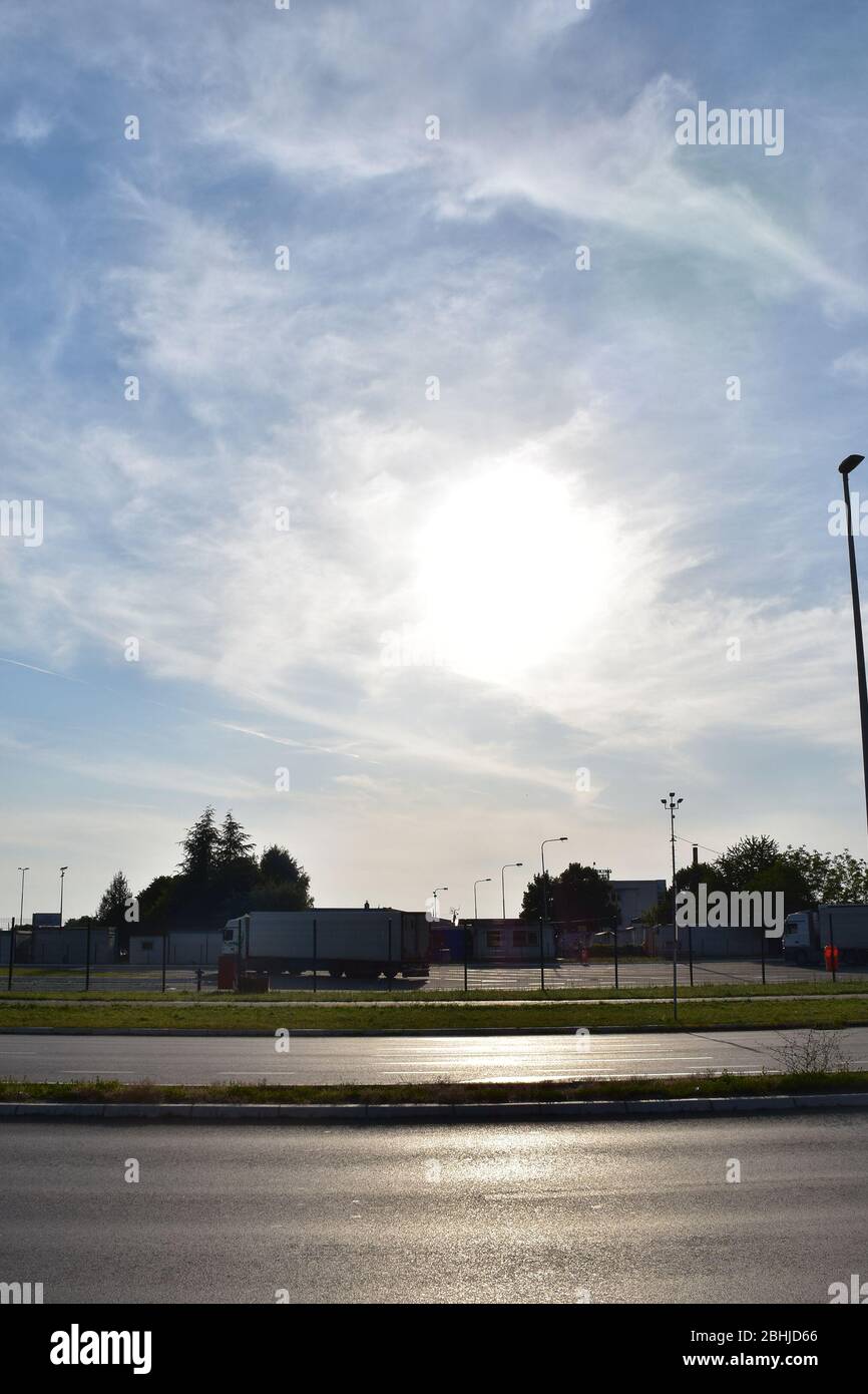 Diffuse light in the sky from the sun behind the clouds and reflection ...