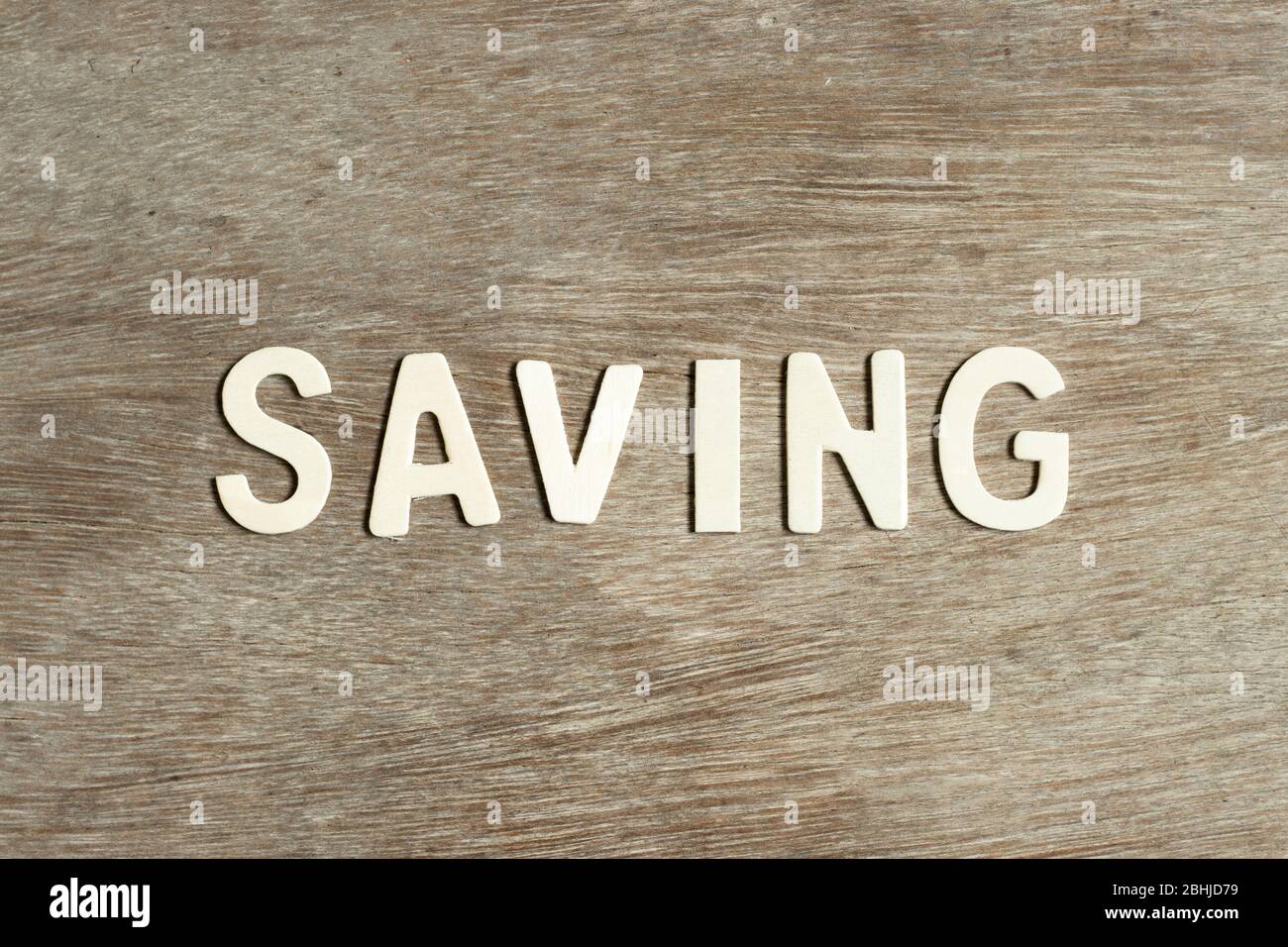 Alphabet letter in word saving on wood background Stock Photo - Alamy