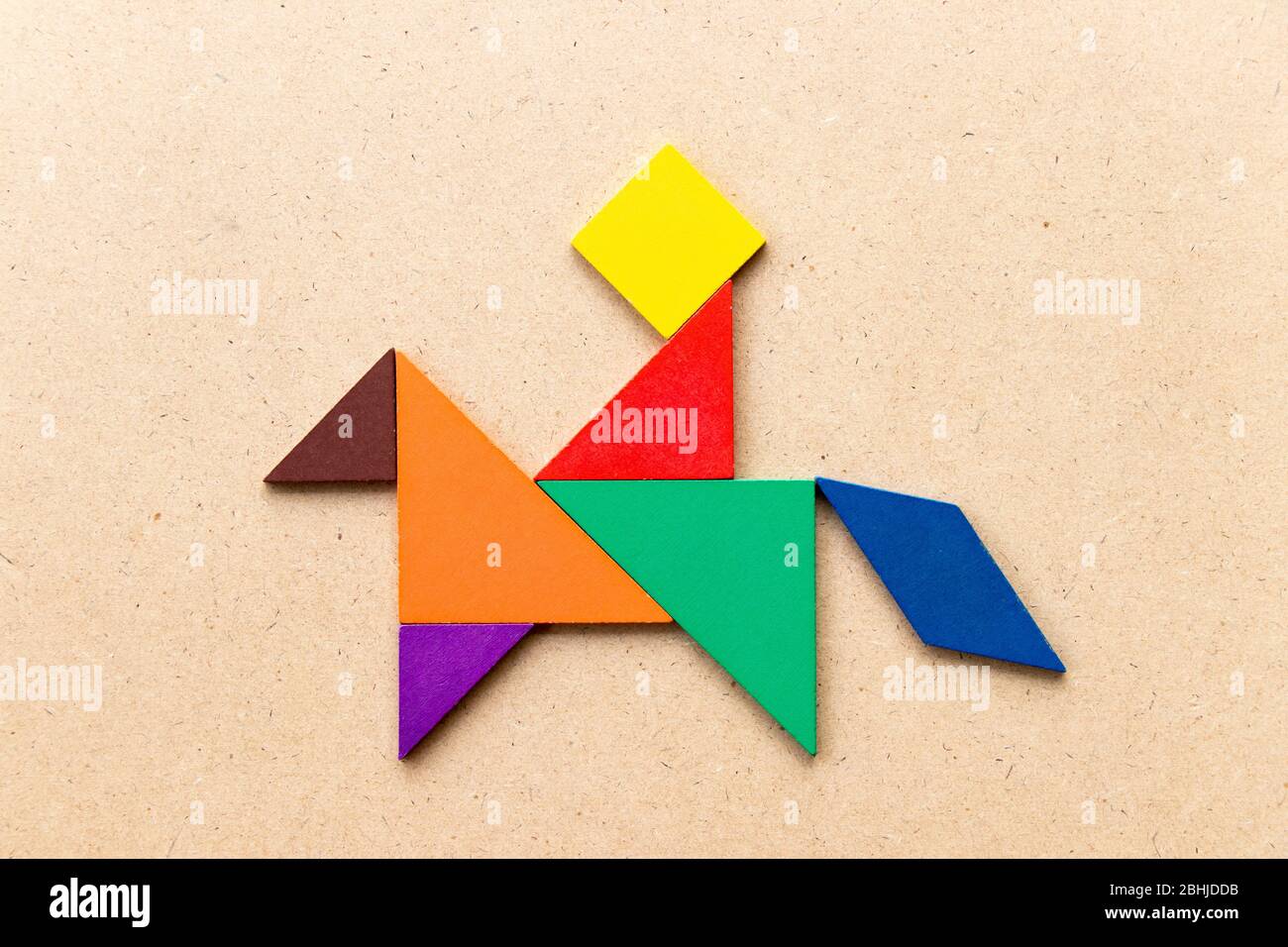 Color tangram puzzle in man ride on the horse shape shape on wood ...