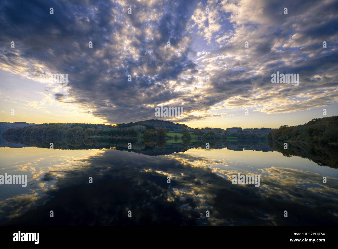 A large band of dark clouds crosses the sky and is reflected on the ...