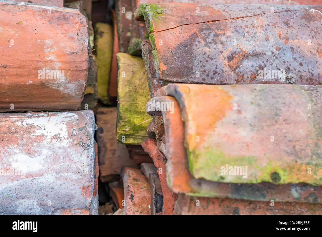Ancient pieces of terracotta roof stacked. Old type of roof used in ...