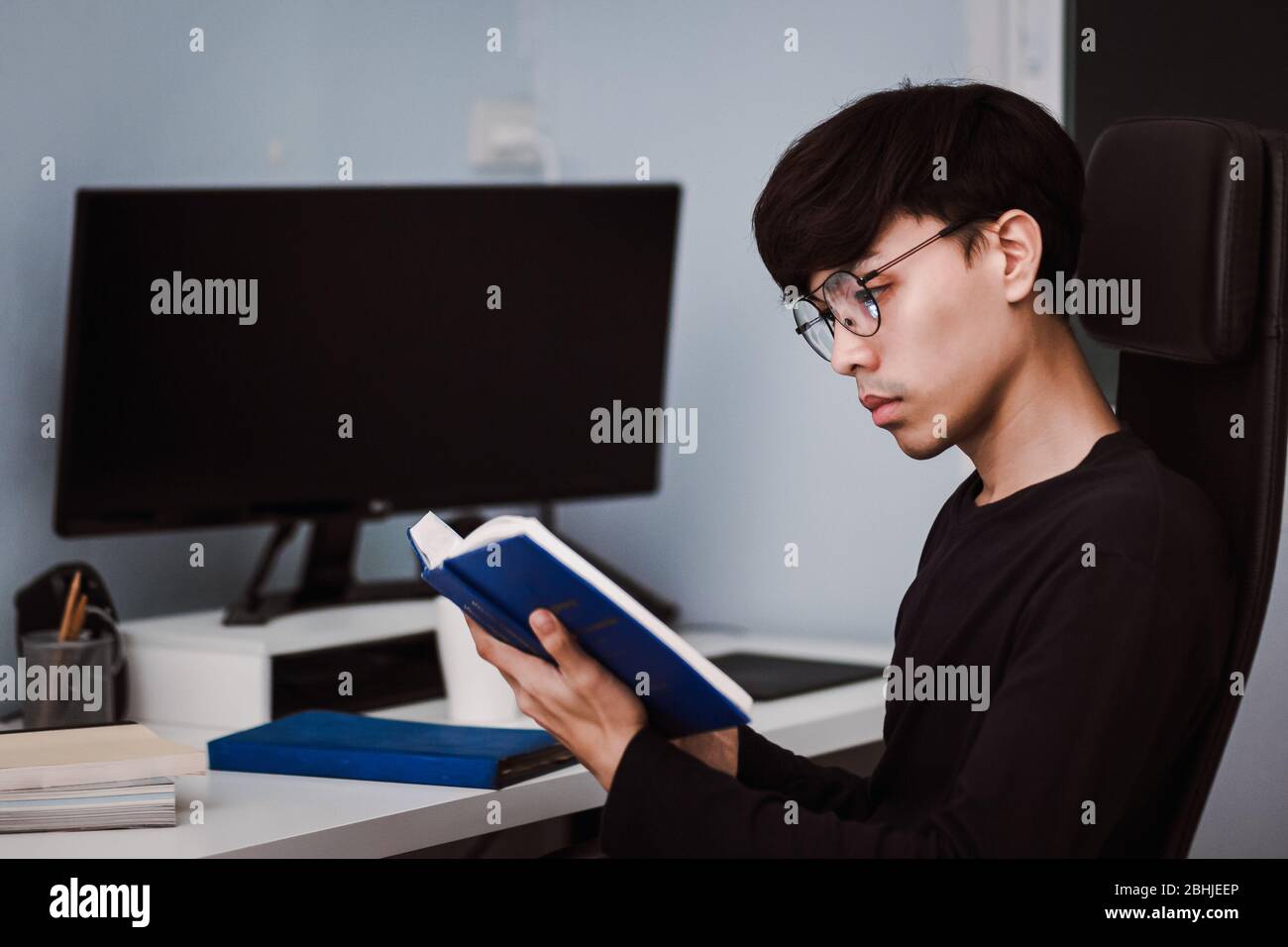 Asian man reading book hi-res stock photography and images - Alamy