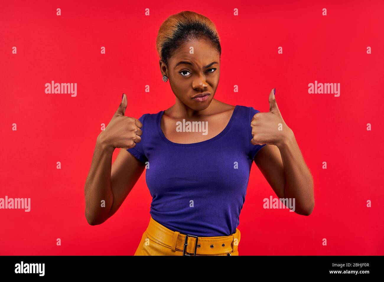 Grinning lady shows a symbol of like - big fingers up Stock Photo - Alamy