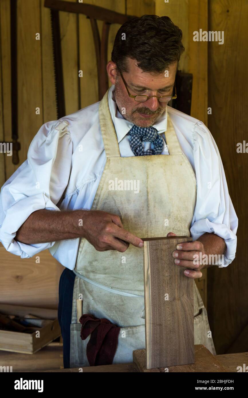 A woodworker demonstrates his skill to visitors at Historic Old Fort ...