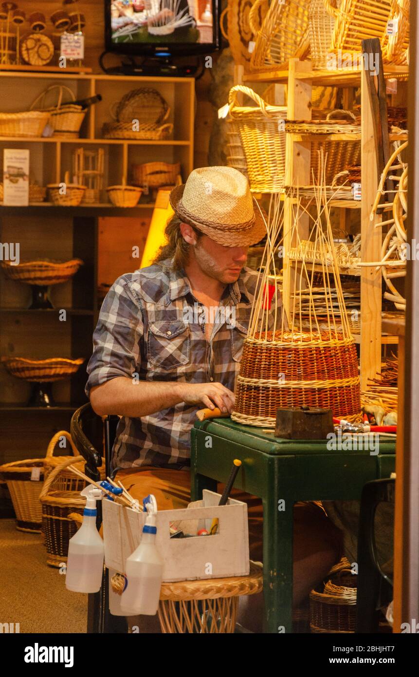 View of a craftsman hand making a basket in his workshop at Yvoire ...