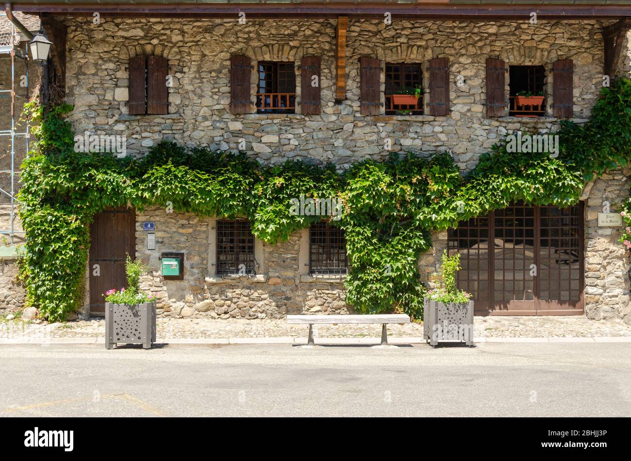 Facade of a beautiful stone wall medieval house in Yvoire, France Stock ...