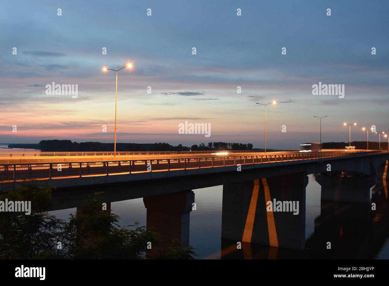 Long Pupin Bridge over the Danube illuminated by orange light from ...