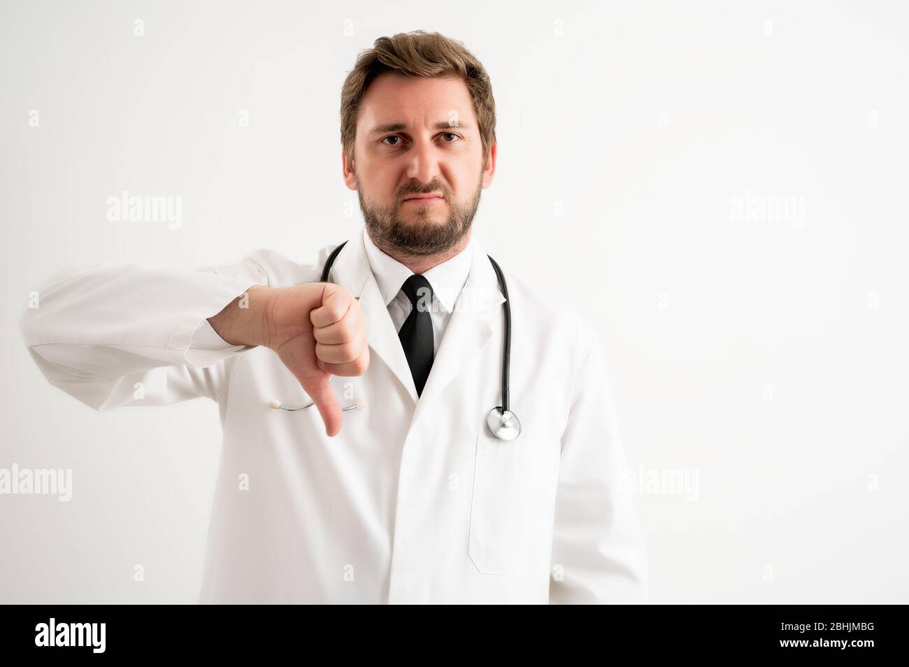Portrait of male doctor with stethoscope in medical uniform showing ...