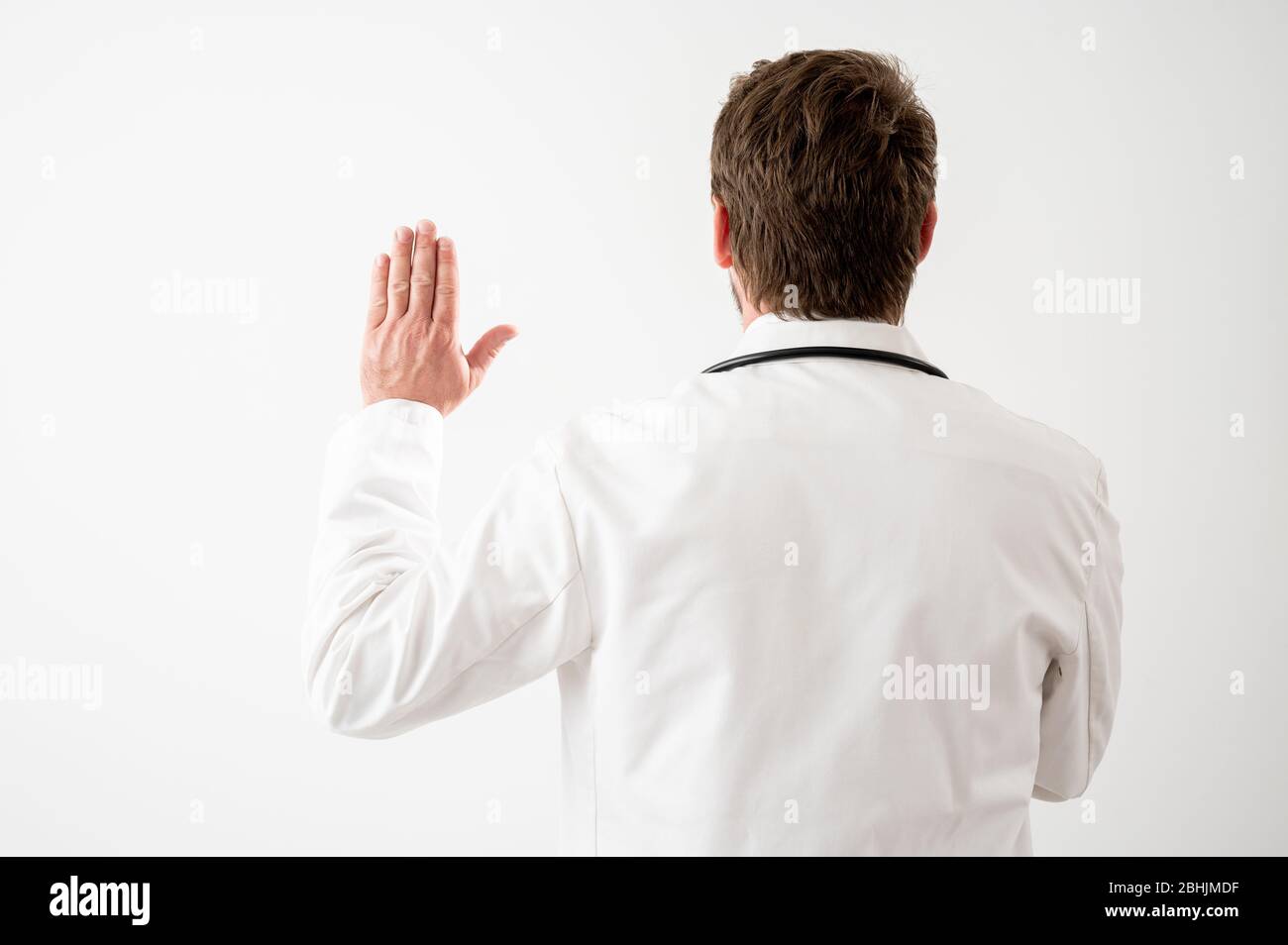 Portrait of male doctor with stethoscope in medical uniform showing ...