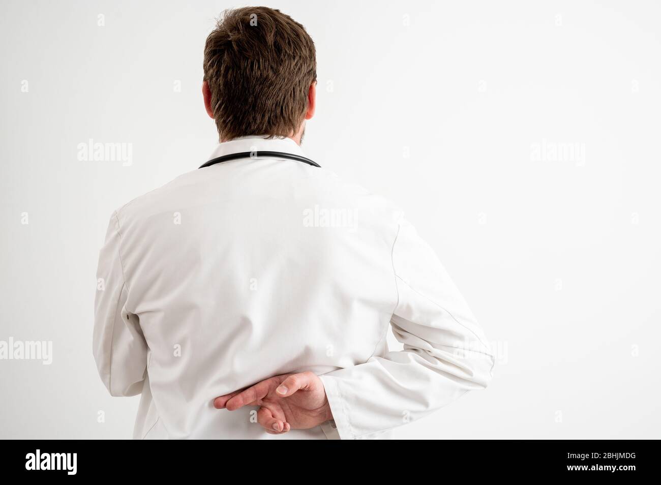 Portrait of male doctor with stethoscope in medical uniform showing ...