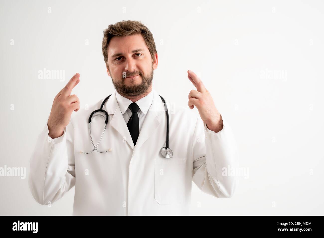Portrait of male doctor with stethoscope in medical uniform showing ...