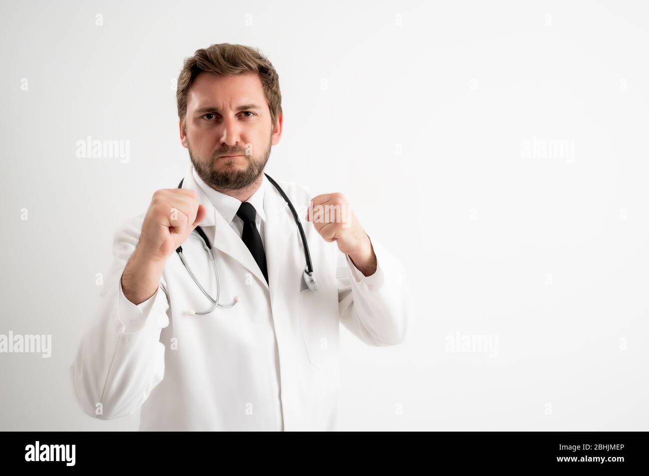 Portrait of male doctor with stethoscope in medical uniform showing ...
