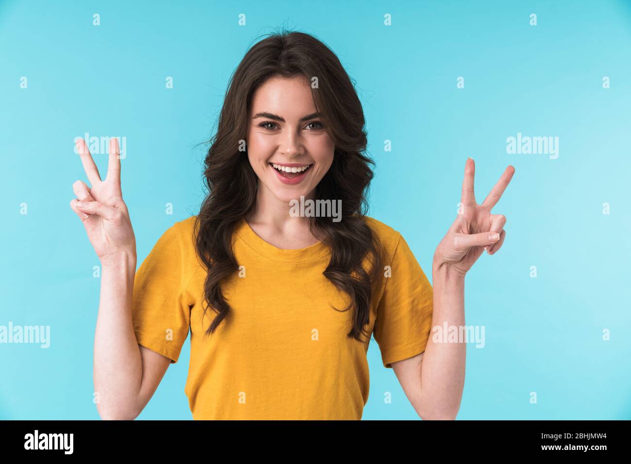 Image of a happy optimistic cheery young pretty woman posing isolated ...