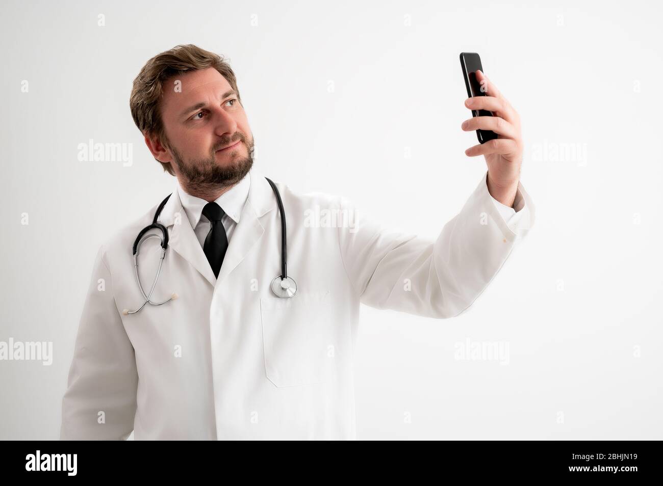 Portrait Of Male Doctor With Stethoscope In Medical Uniform Taking