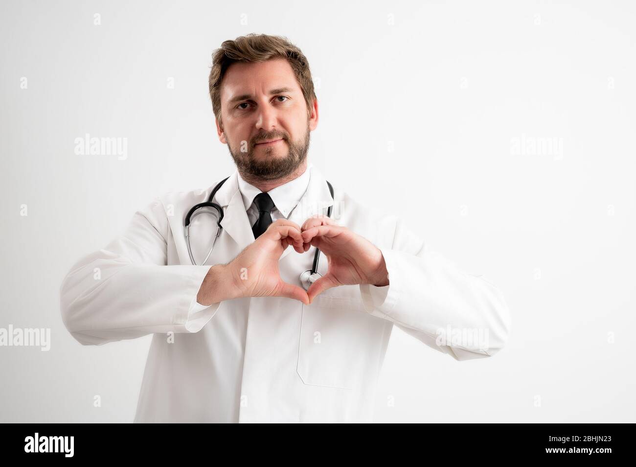 Portrait of male doctor with stethoscope in medical uniform showing ...