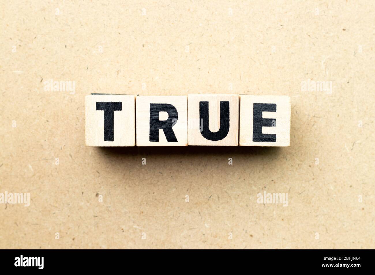 Letter block in word true on wood background Stock Photo - Alamy