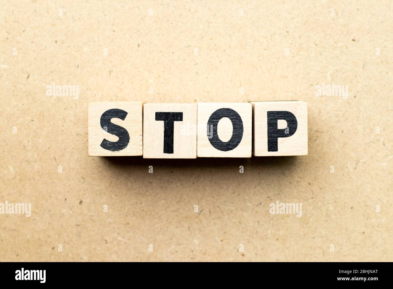 Letter block in word stop on wood background Stock Photo - Alamy