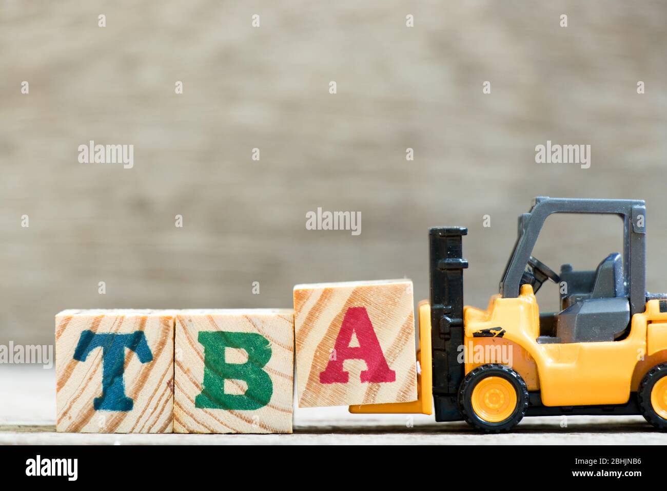 Toy forklift hold letter block in word TBA (abbreviation of to be ...