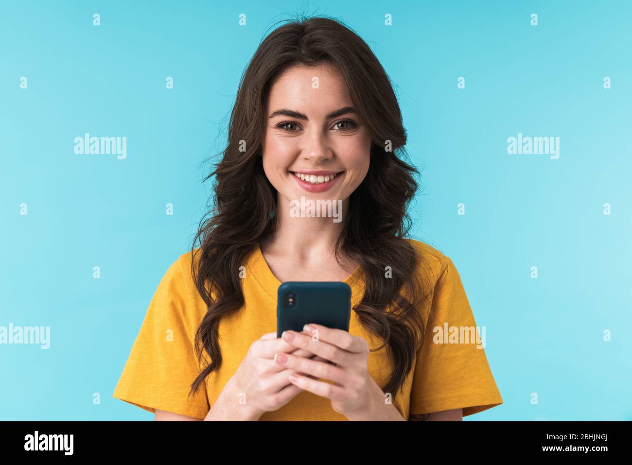 Image of a happy optimistic young pretty woman posing isolated over ...