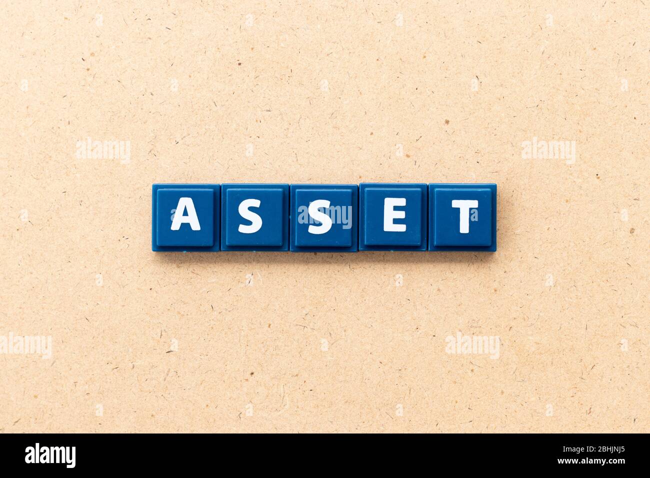 Tile letter in word asset on wood background Stock Photo - Alamy