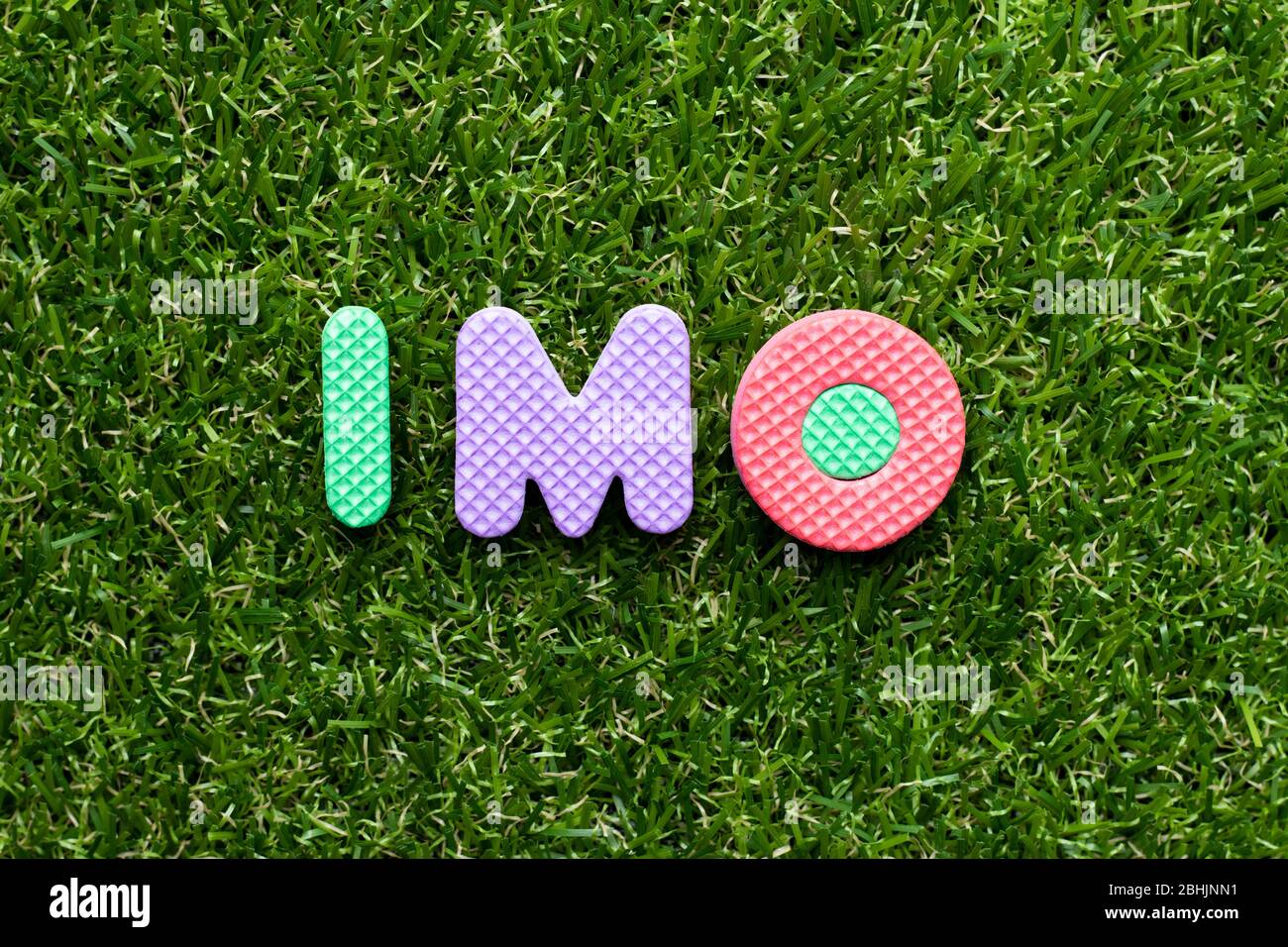 Toy foam letter in word IMO (Abbreviation of in my opinion) on green ...