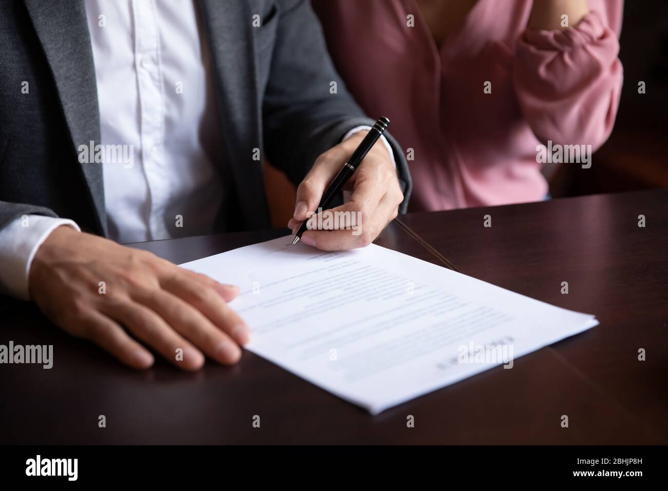 Caucasian couple sign agreement closing deal in cafe Stock Photo - Alamy