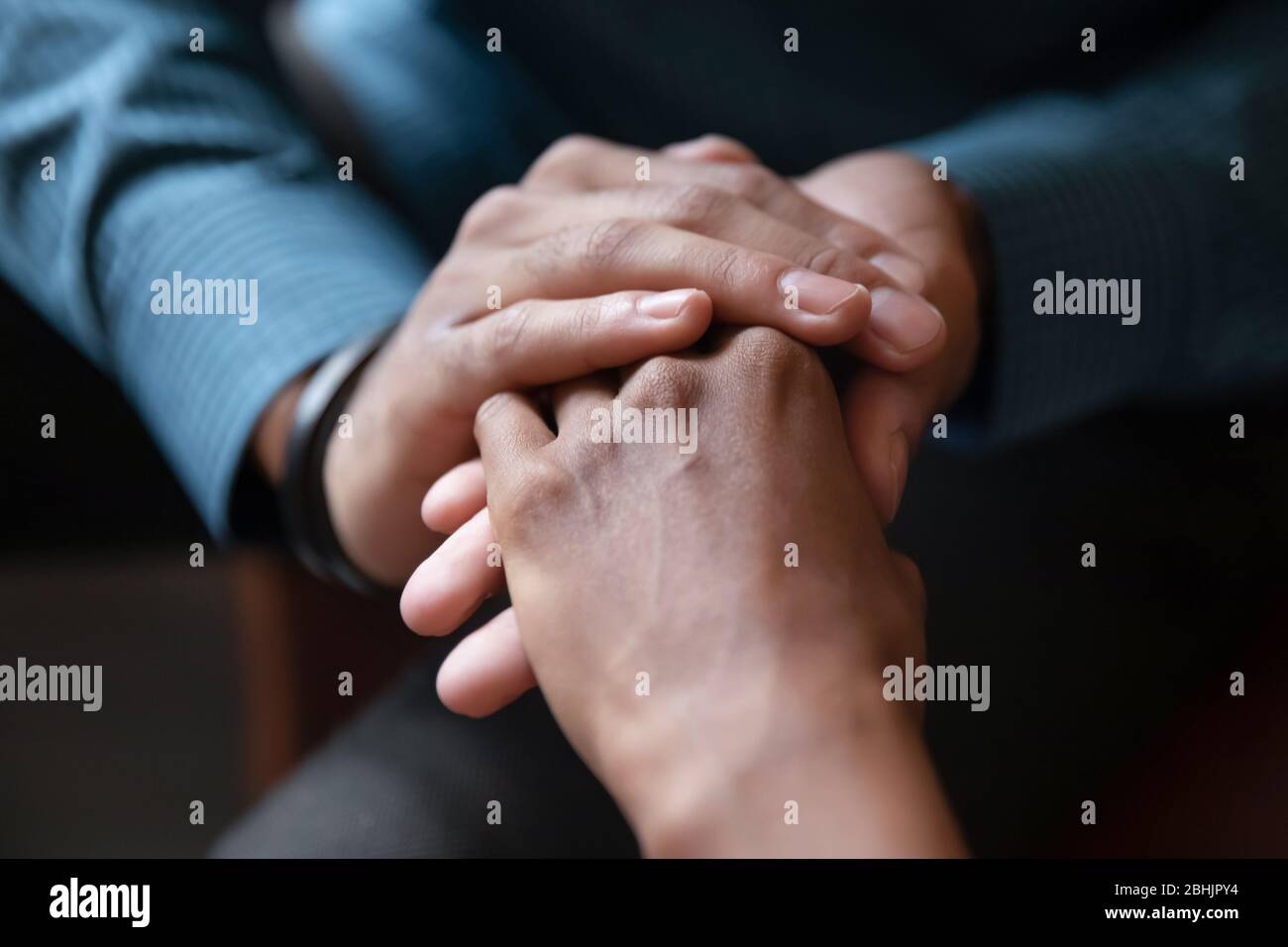 Multiethnic couple hold hands sharing close intimate moment together ...