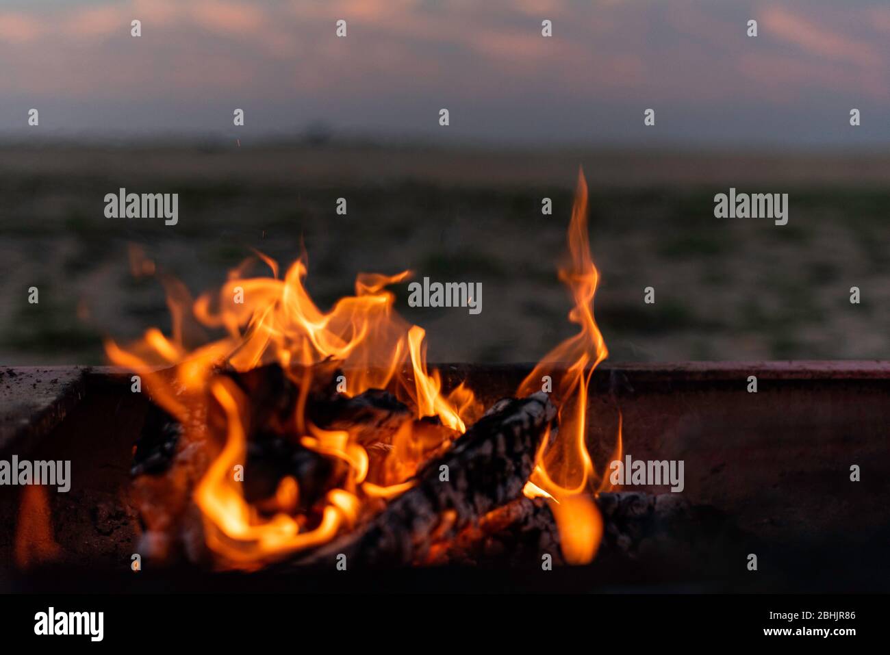 A photo of a summer night outdoor campfire of burning firewood and the ...