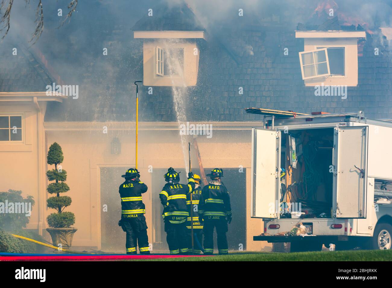 Group of firefighters fighting fire at 84 Castlemere Place, North ...