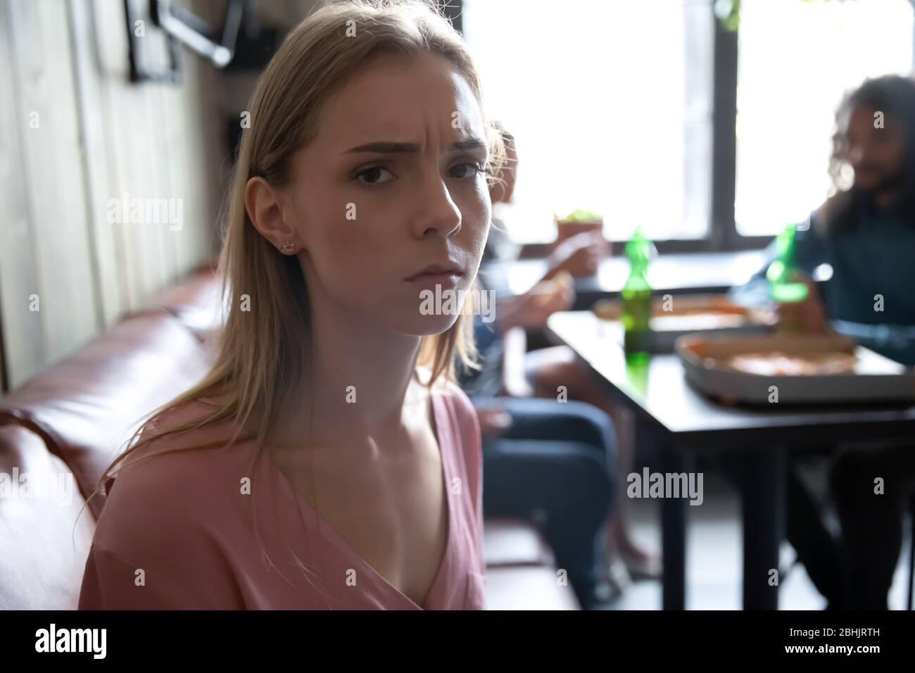 Stressed millennial girl outcast sit alone in cafe Stock Photo - Alamy