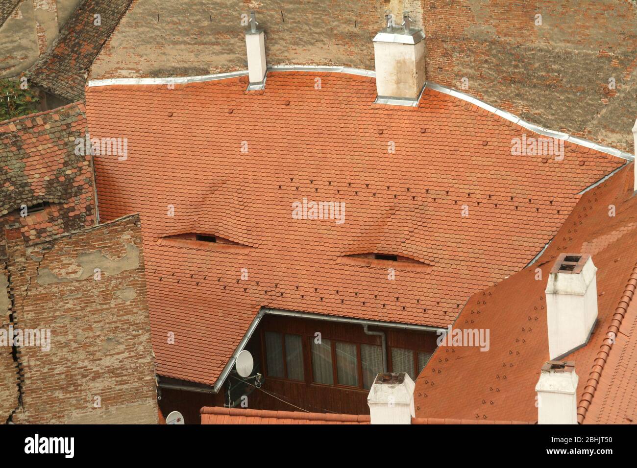 Sibiu, Romania. Traditional clay roof with eye-like openings in the ...