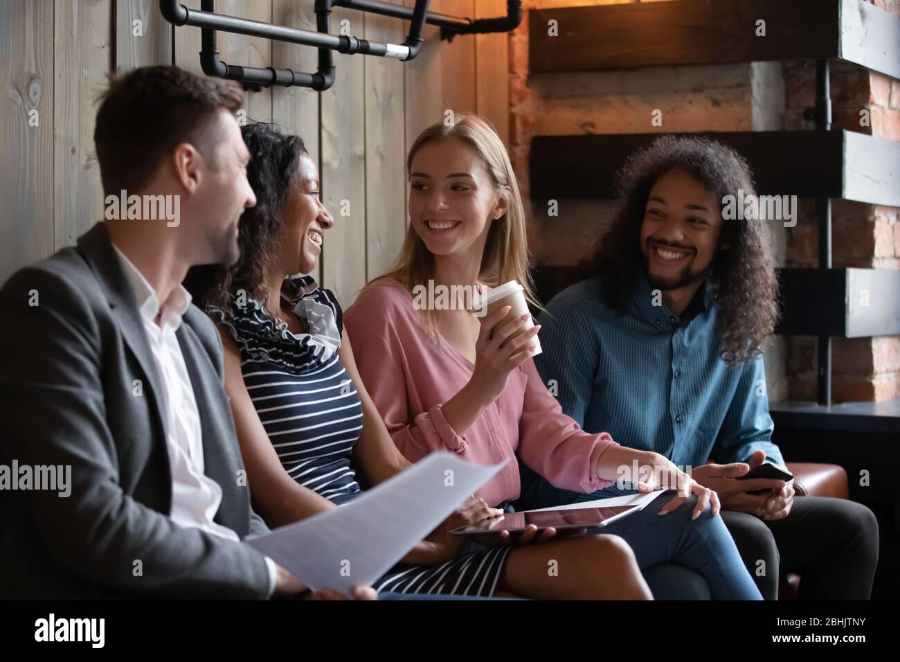 Diverse group people sitting couch hi-res stock photography and images ...
