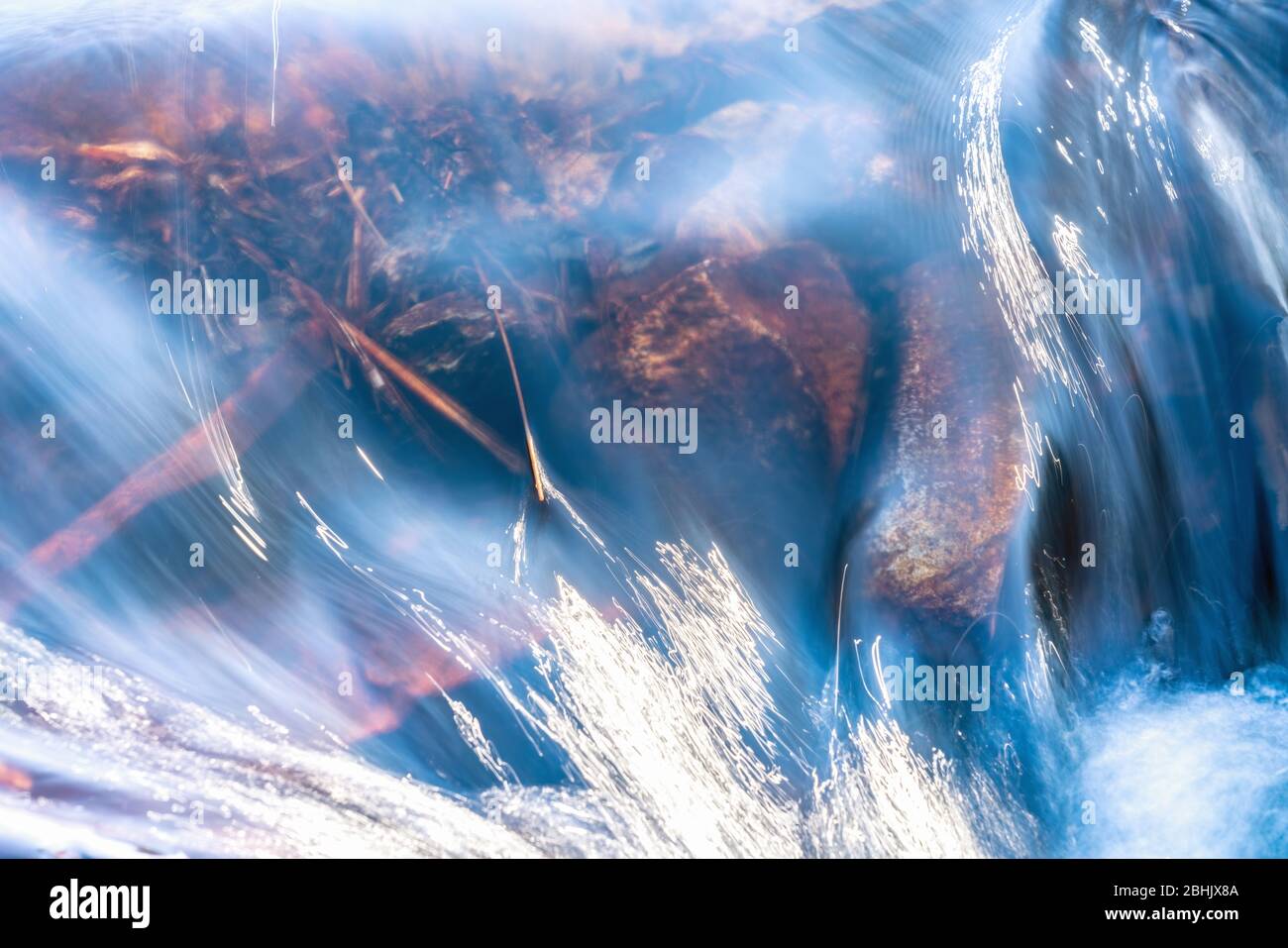 Very close up view at crystal clear water running from mountains in ...