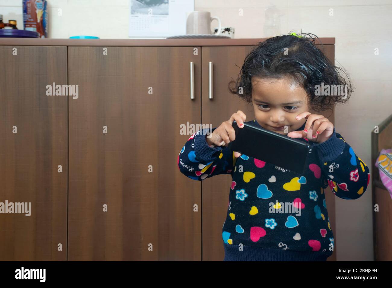 young Child using a mobile phone Stock Photo - Alamy