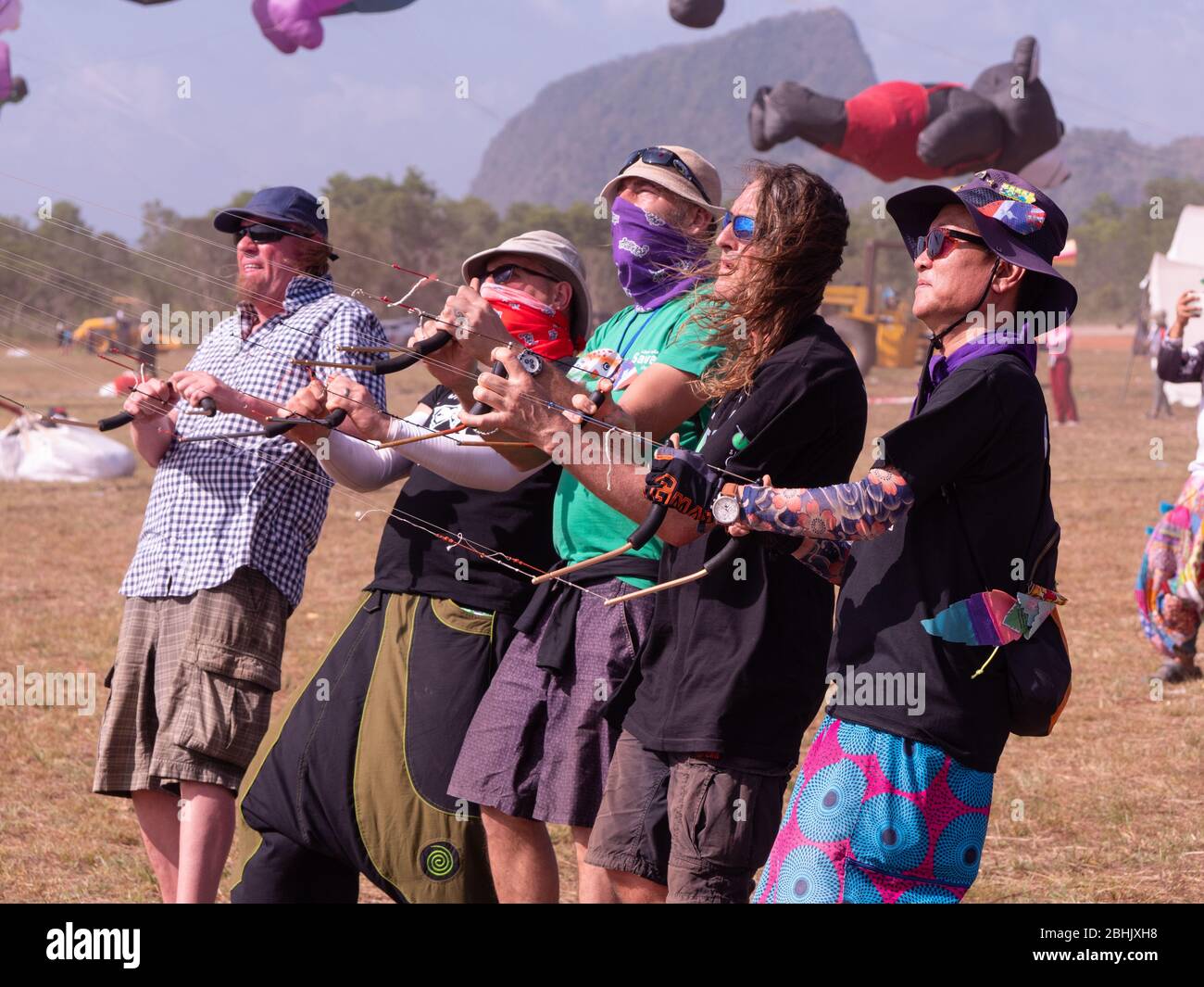 Five kite flyers flying quad line sports kites at Satun International ...