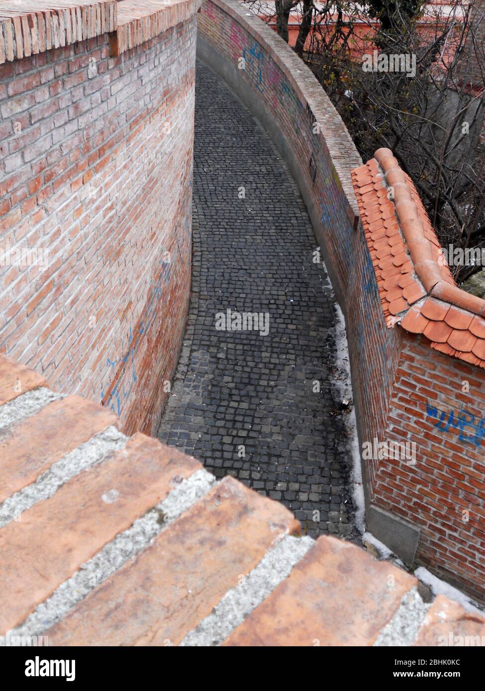 Sibiu, Romania. Cobblestone path between the medieval fortifying walls ...