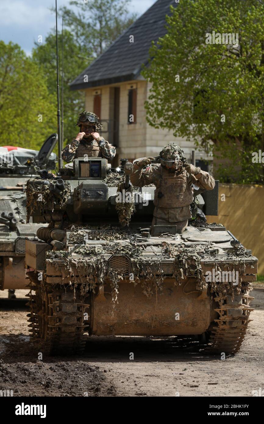 the crew of a Latvian Army Scimitar CVR(T) preparing to move during ...