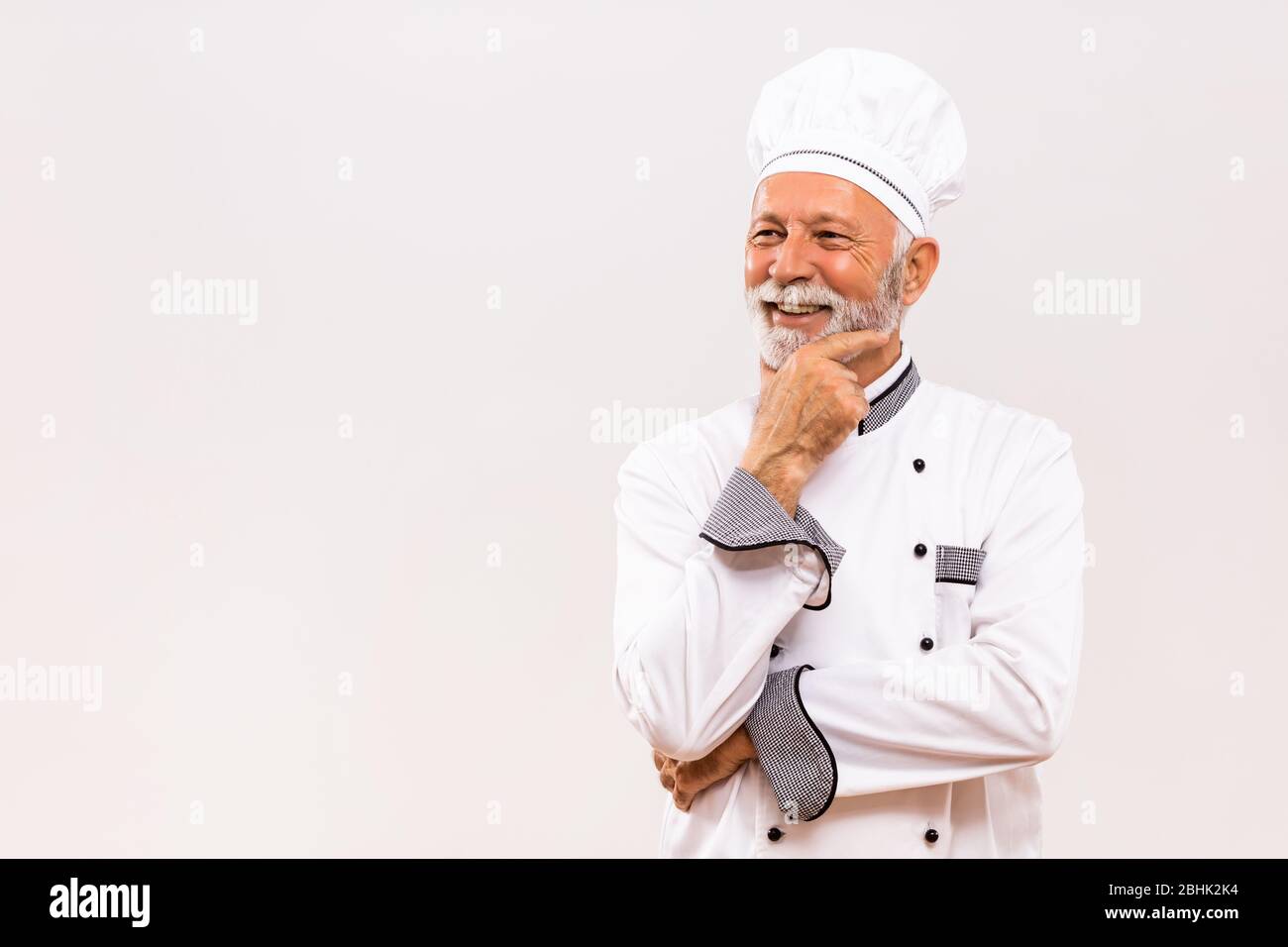 Portrait of senior chef thinking on gray background Stock Photo - Alamy